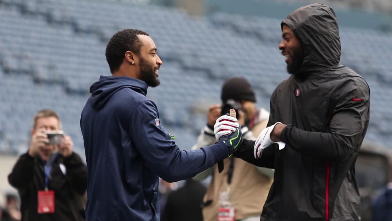 Baldwin and Sherman hug during warm-ups