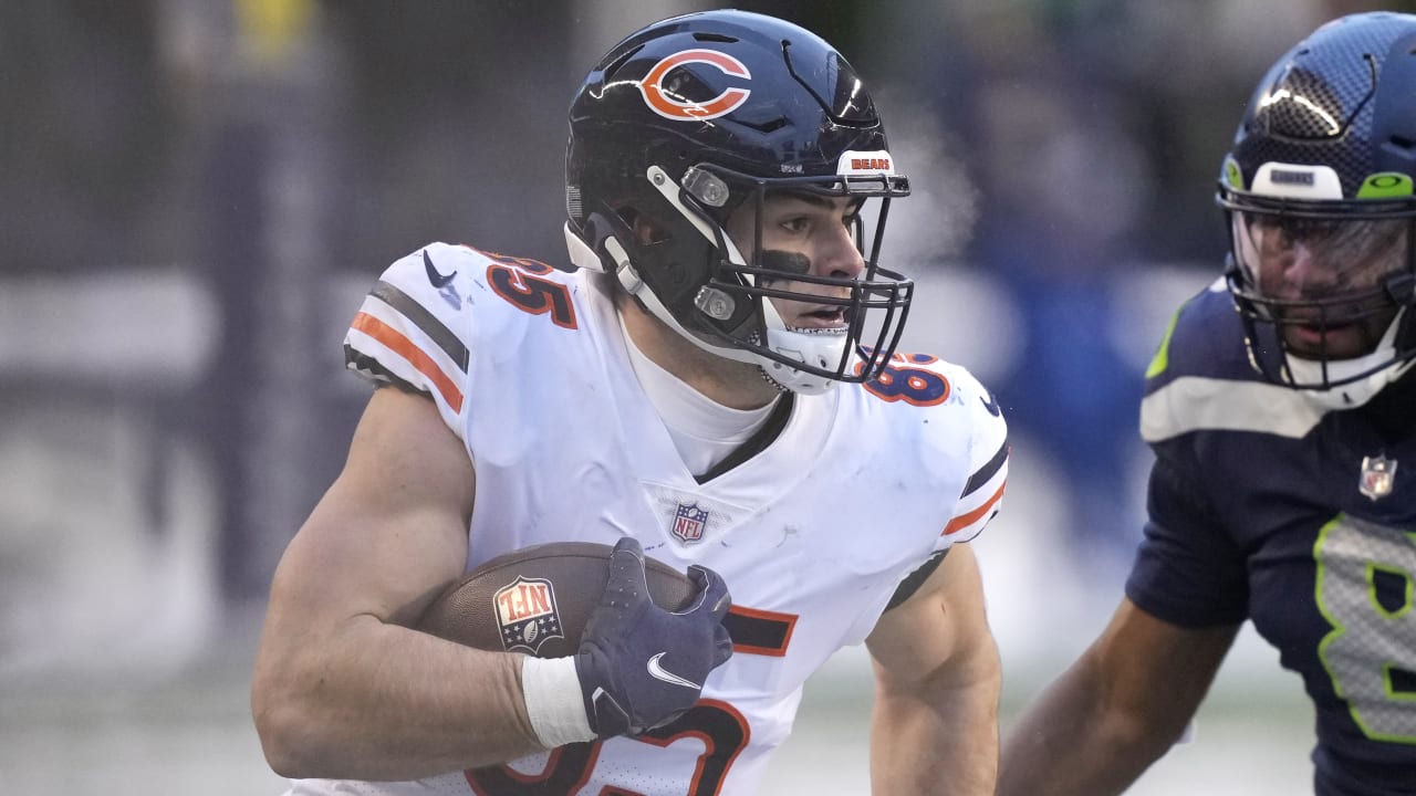 Chicago Bears rookie tight end Cole Kmet fends off a would-be tackler ...