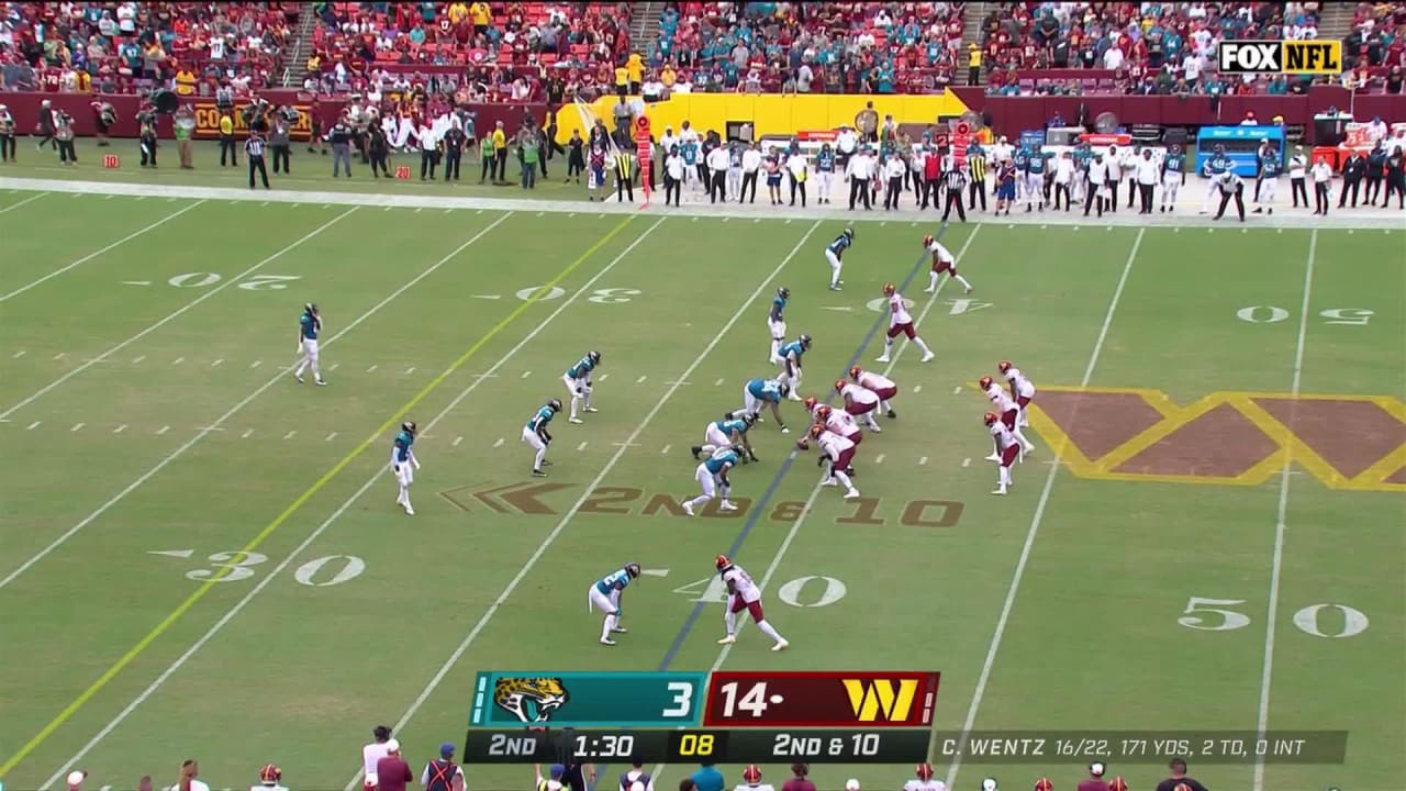 Jacksonville Jaguars linebacker Josh Allen pokes the ball out of Curtis ...