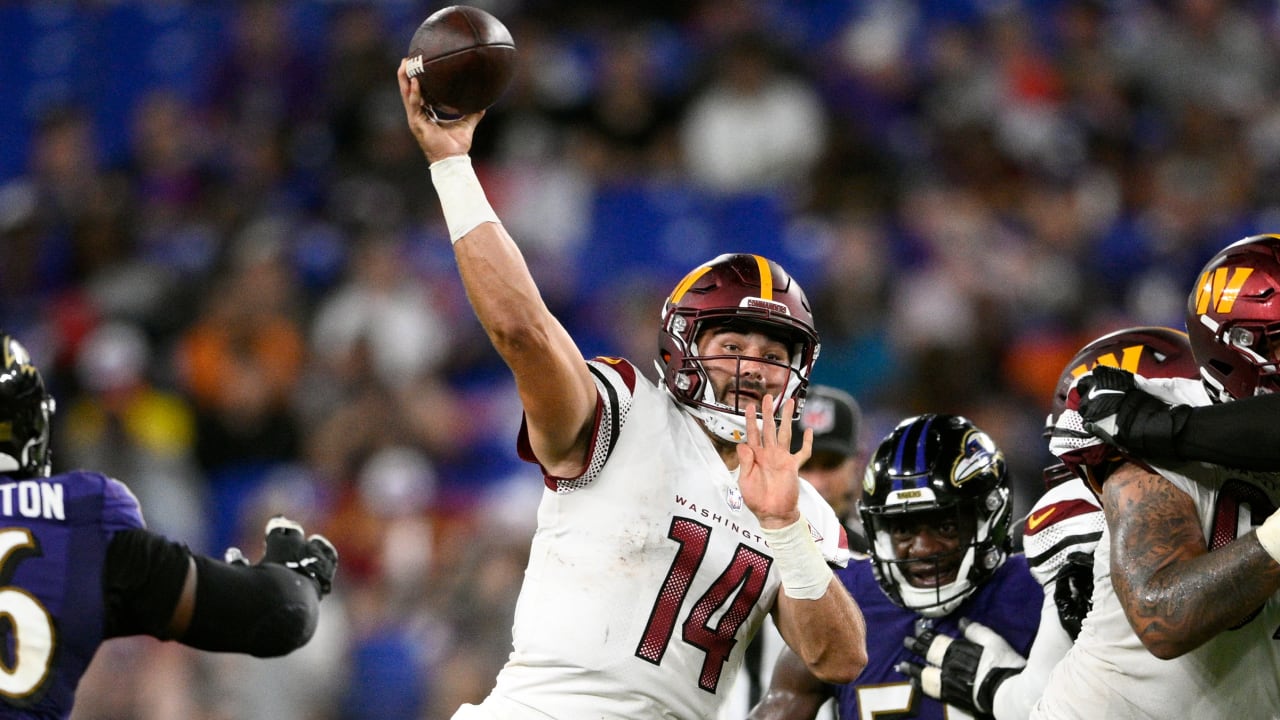 Washington Commanders quarterback Sam Howell fires a strike to tight ...