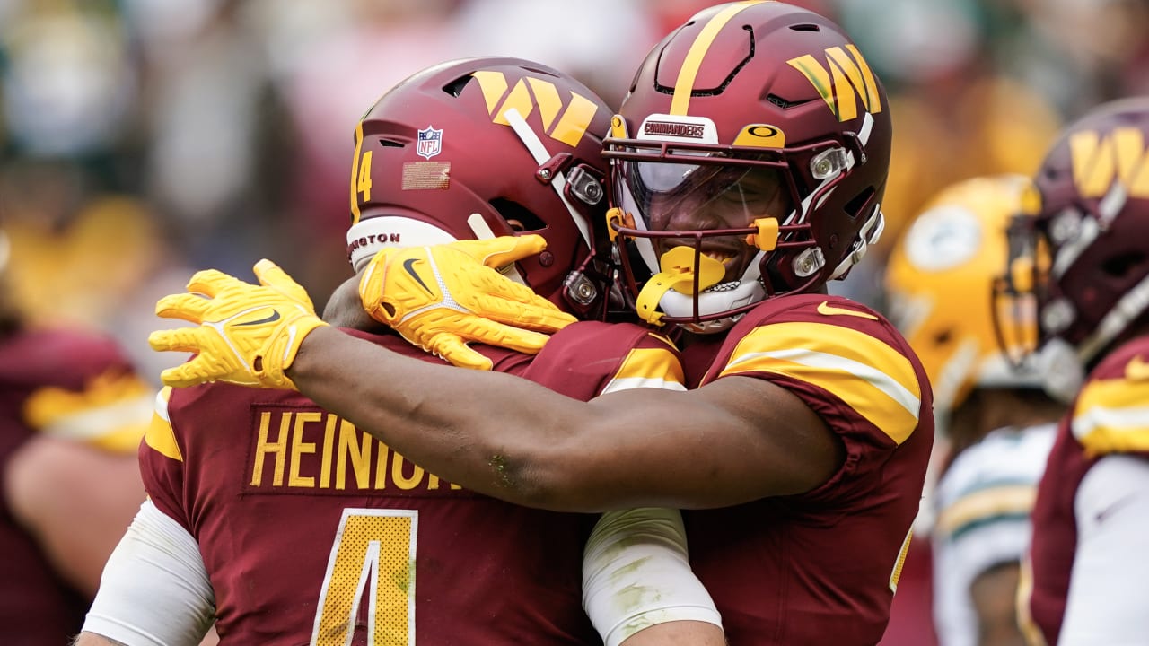 Washington Commanders quarterback Taylor Heinicke dots running back ...