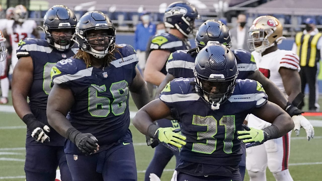 Seattle Seahawks running back DeeJay Dallas drives into the end zone ...