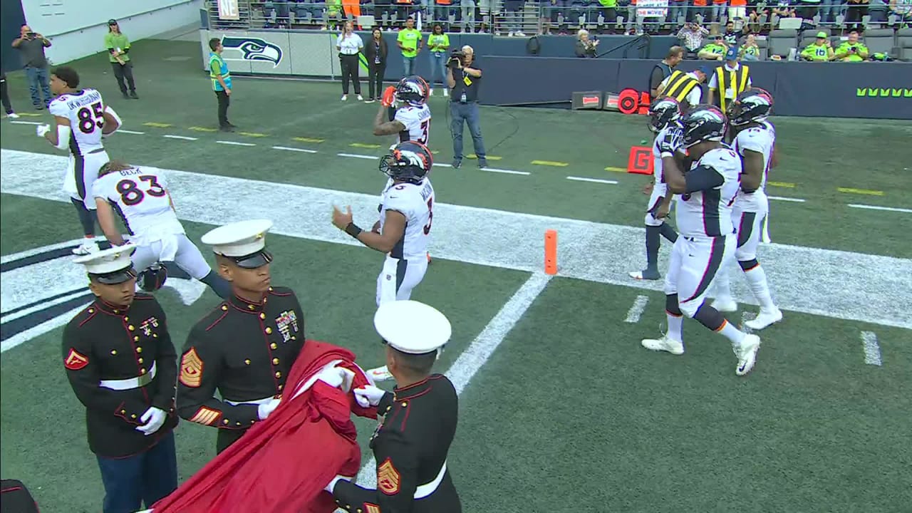 Denver Broncos quarterback Russell Wilson, Broncos teammates run onto ...