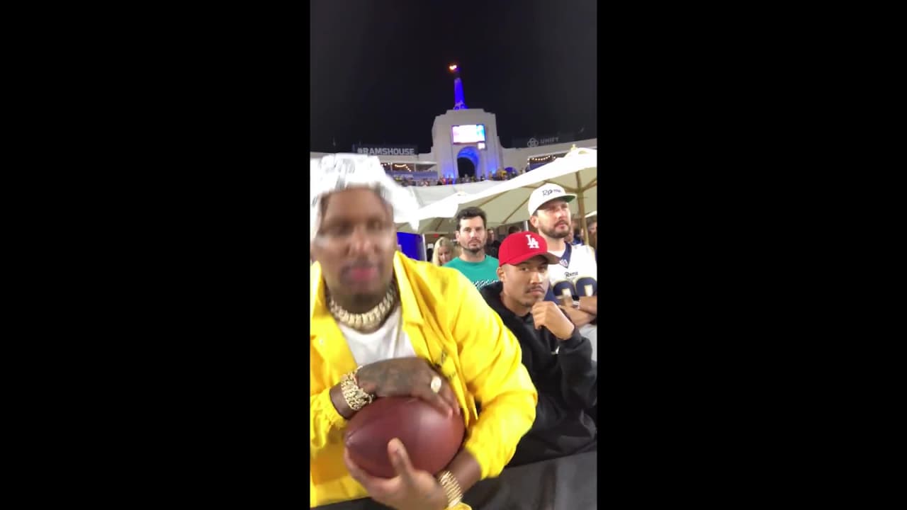 Rapper YG receives touchdown ball from Robert Woods