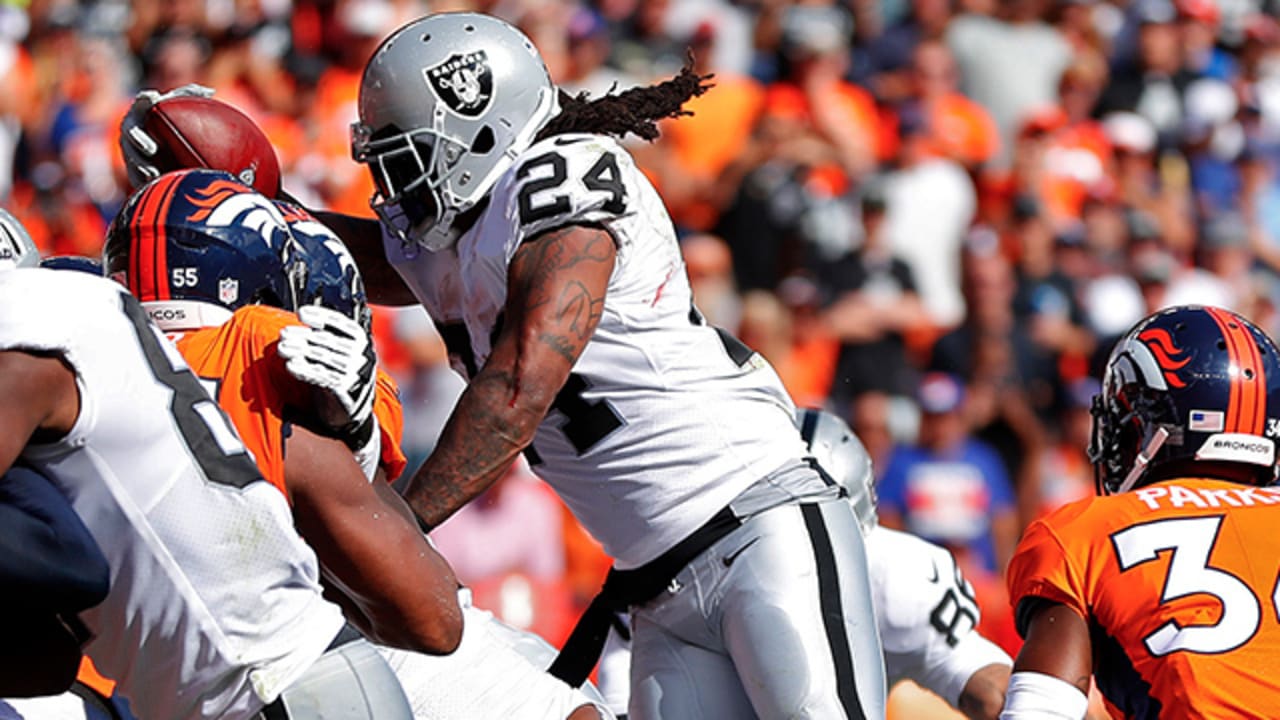 Marshawn Lynch leaps over the line for a 1-yard TD