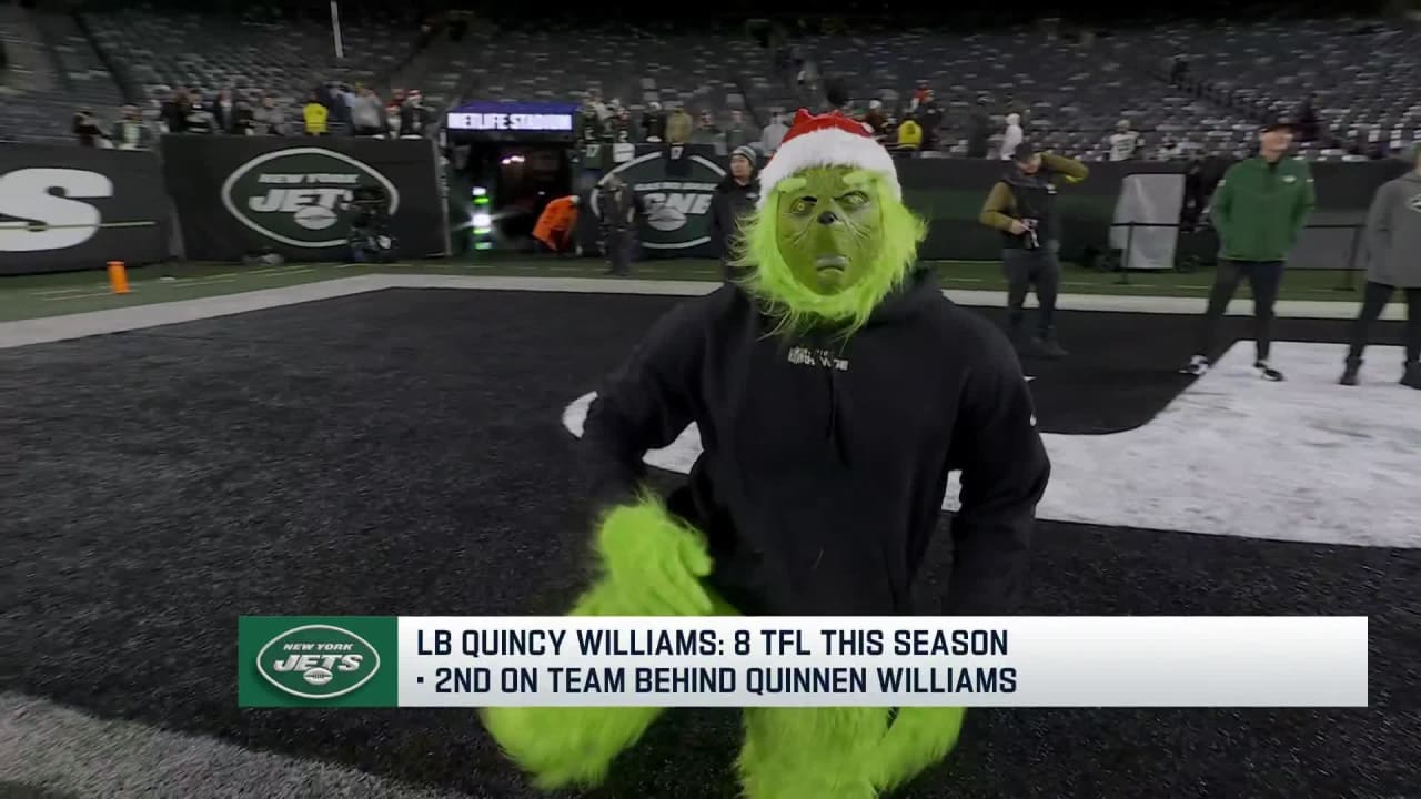 New York Jets linebacker Quincy Williams wears a Grinch costume to warm ...