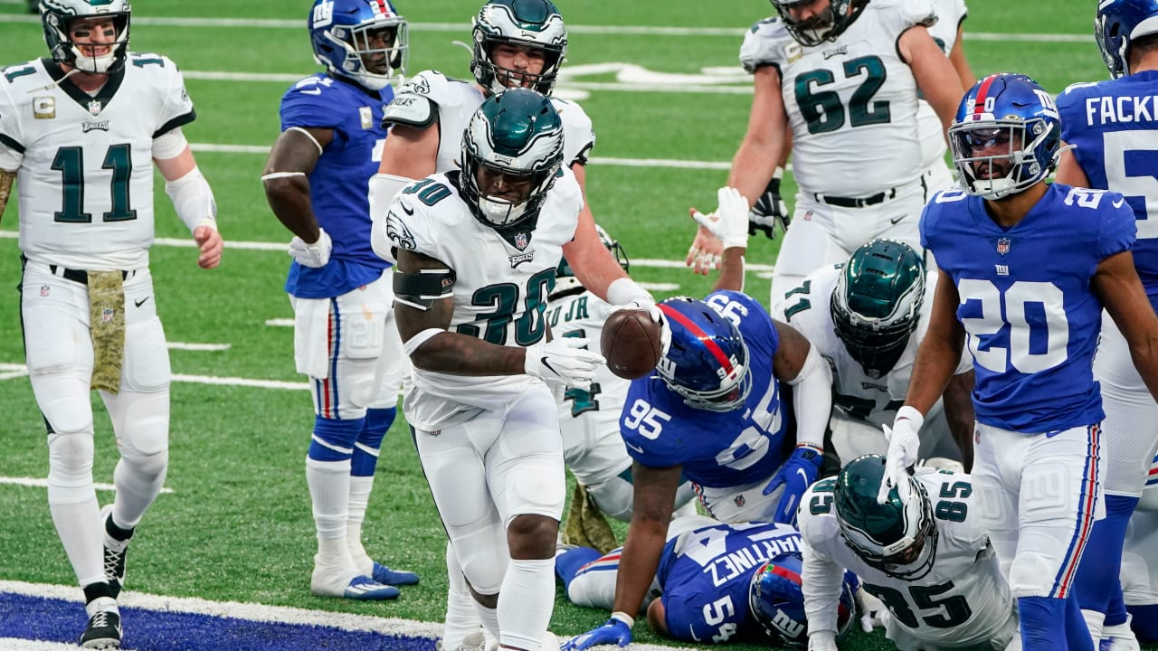 Philadelphia Eagles running back Corey Clement withstands aerial ...
