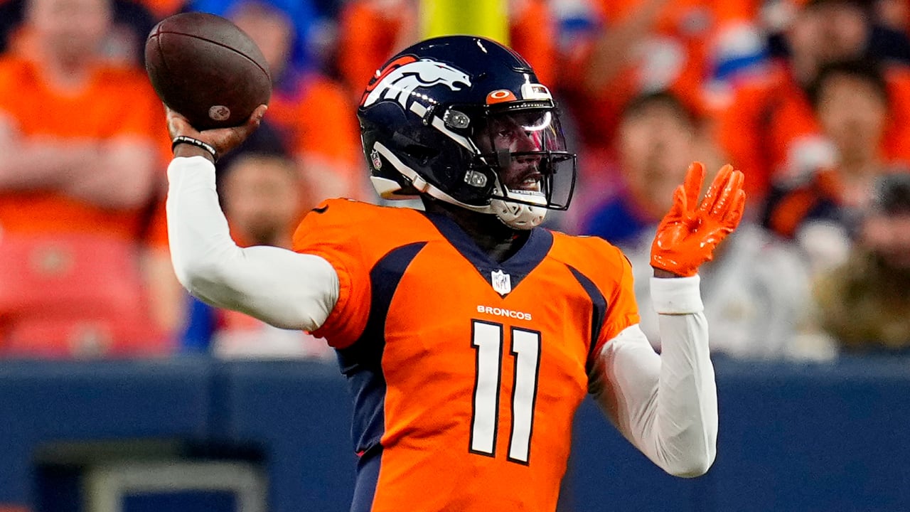 Denver Broncos quarterback Josh Johnson lofts it up for wide receiver a ...
