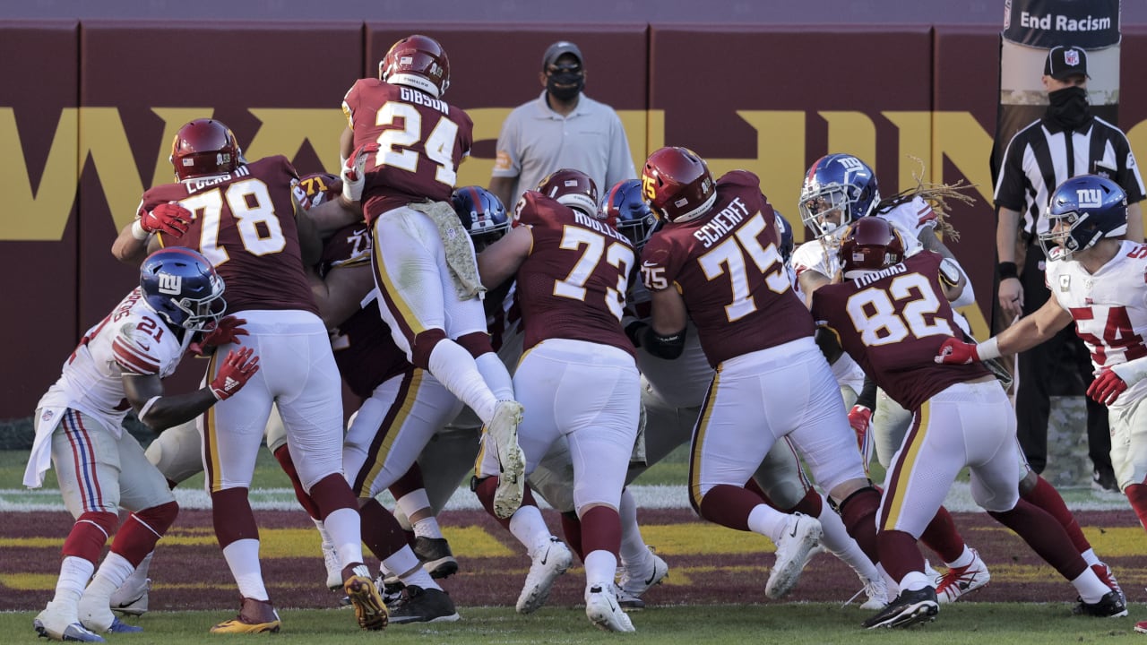 Washington Football Team running back Antonio Gibson dives over the ...
