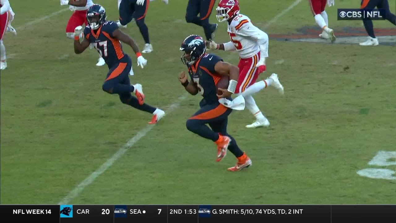 Denver Broncos quarterback Russell Wilson takes a read-option play for ...