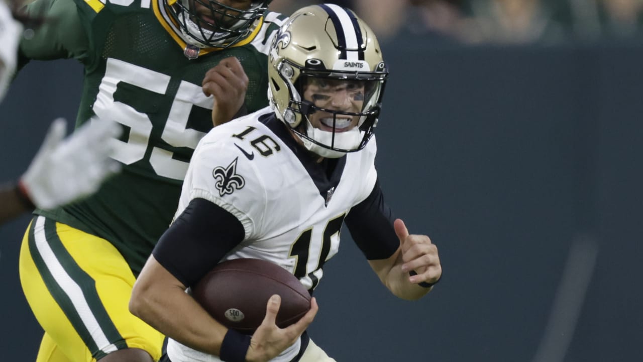 New Orleans Saints quarterback Ian Book evades the rush and gallops ...