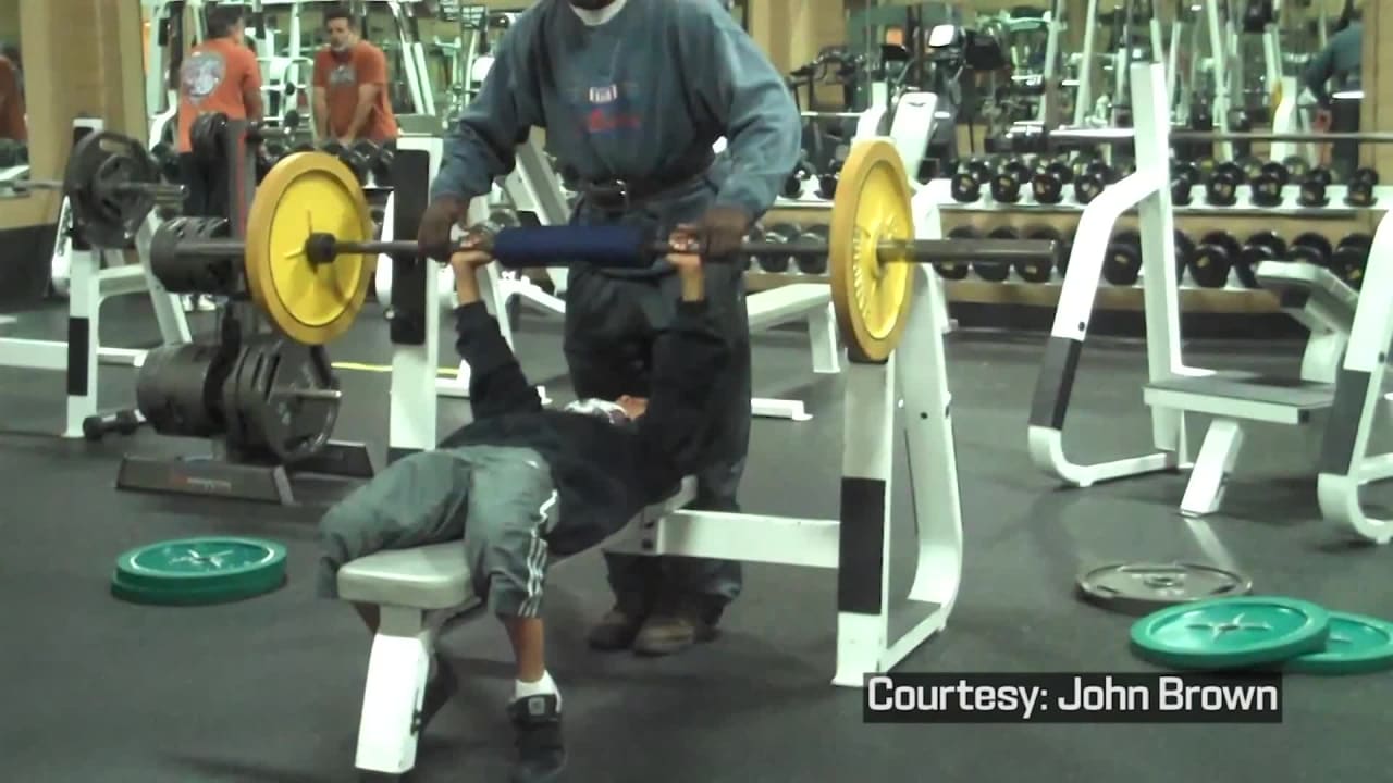 9-year-old Amon-Ra St. Brown lifts weights with his dad John Brown