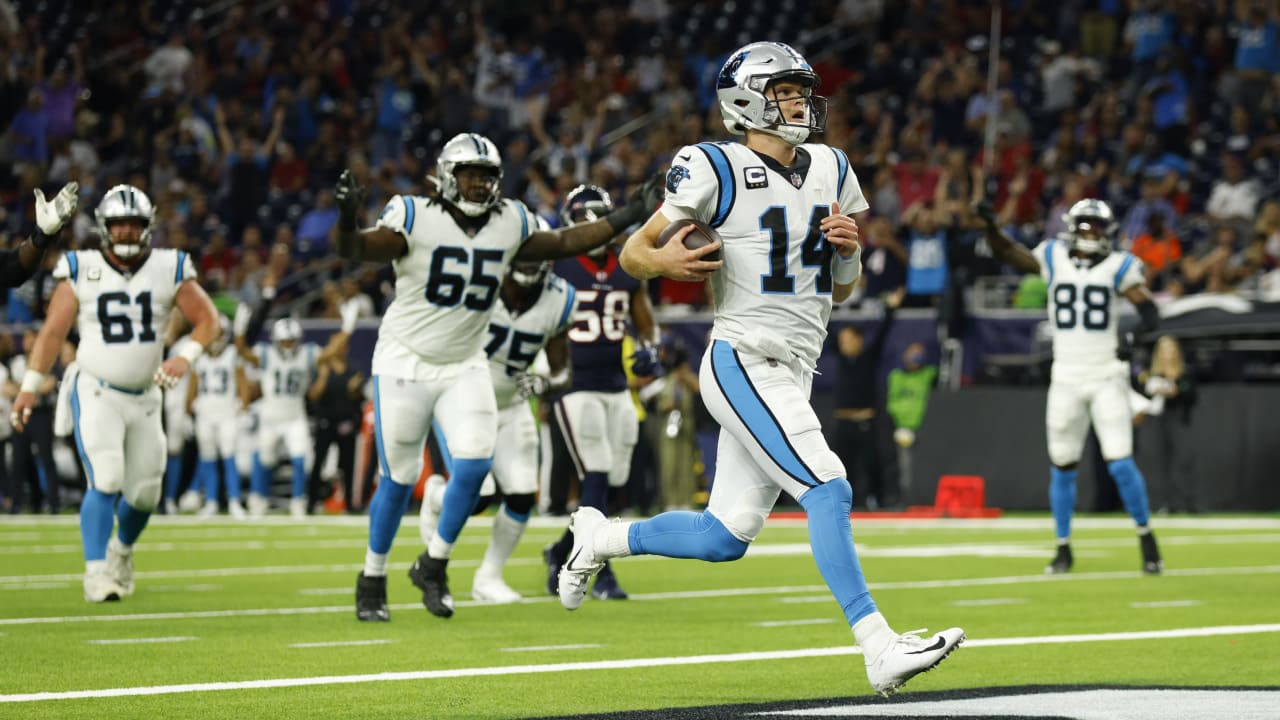Carolina Panthers quarterback Sam Darnold follows tight end Dan Arnold ...