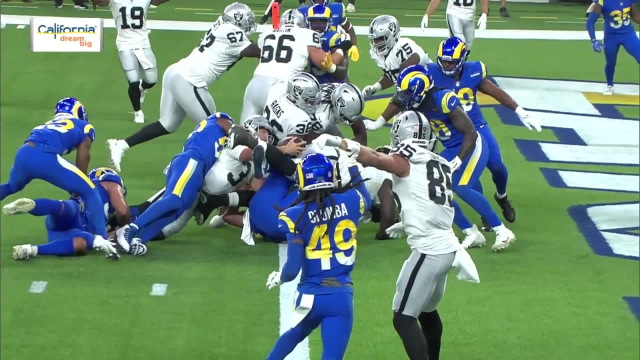 Las Vegas Raiders rookie running back Trey Ragas goes airborne for a ...