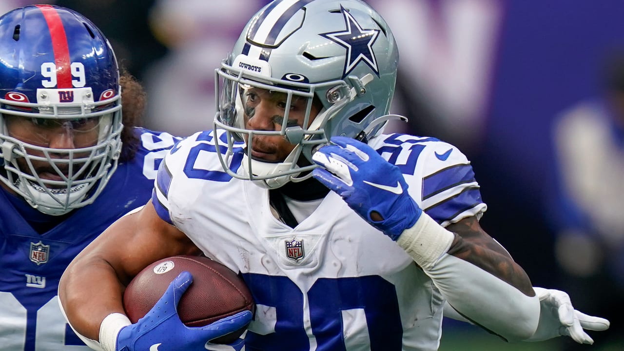 Dallas Cowboys running back Tony Pollard squeezes through a crease for ...