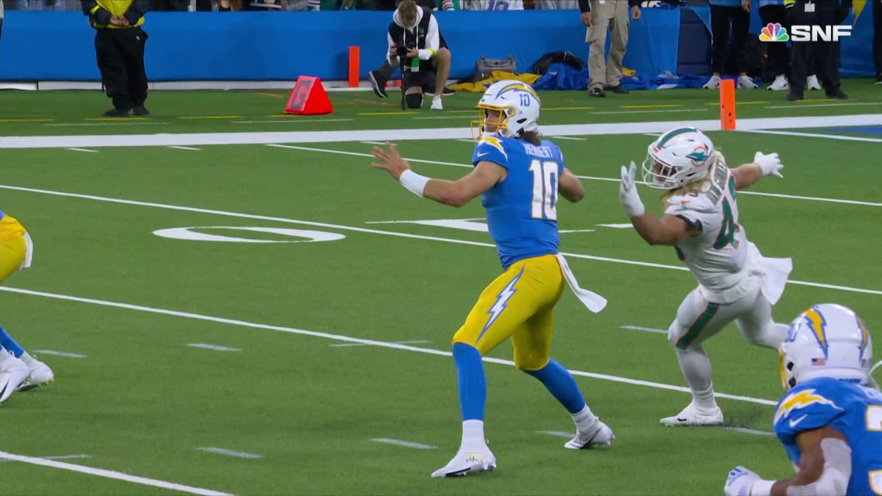 Los Angeles Chargers quarterback Justin Herbert narrowly avoids a strip ...