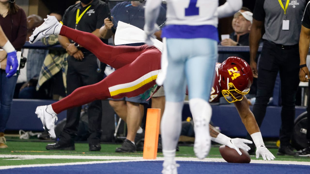 Washington Football Team running back Antonio Gibson dives at the left ...
