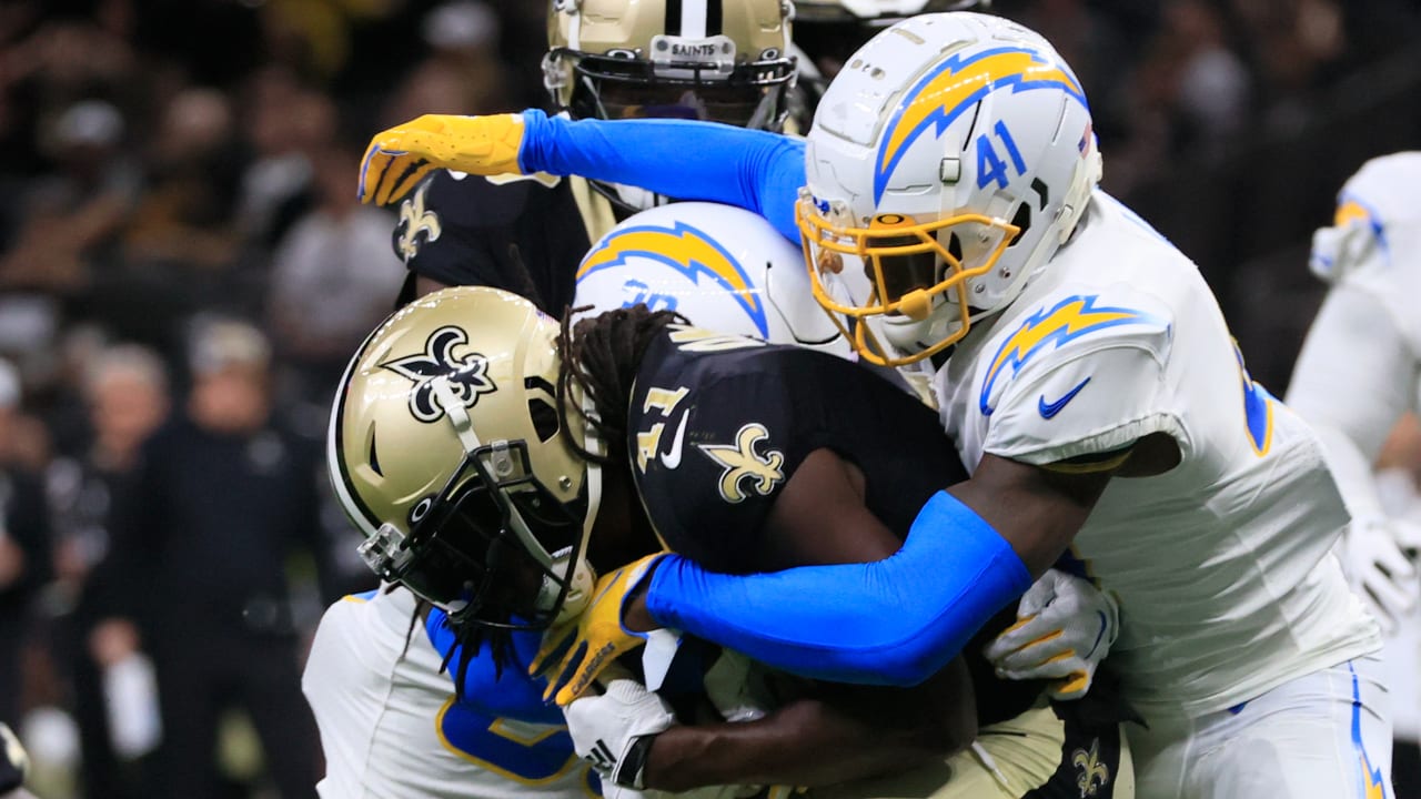 New Orleans Saints running back Alvin Kamara carries multiple defenders ...