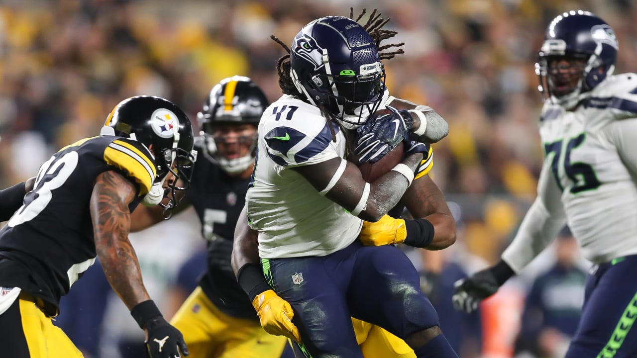 Seattle Seahawks running back Alex Collins hits the hole for a 21-yard ...