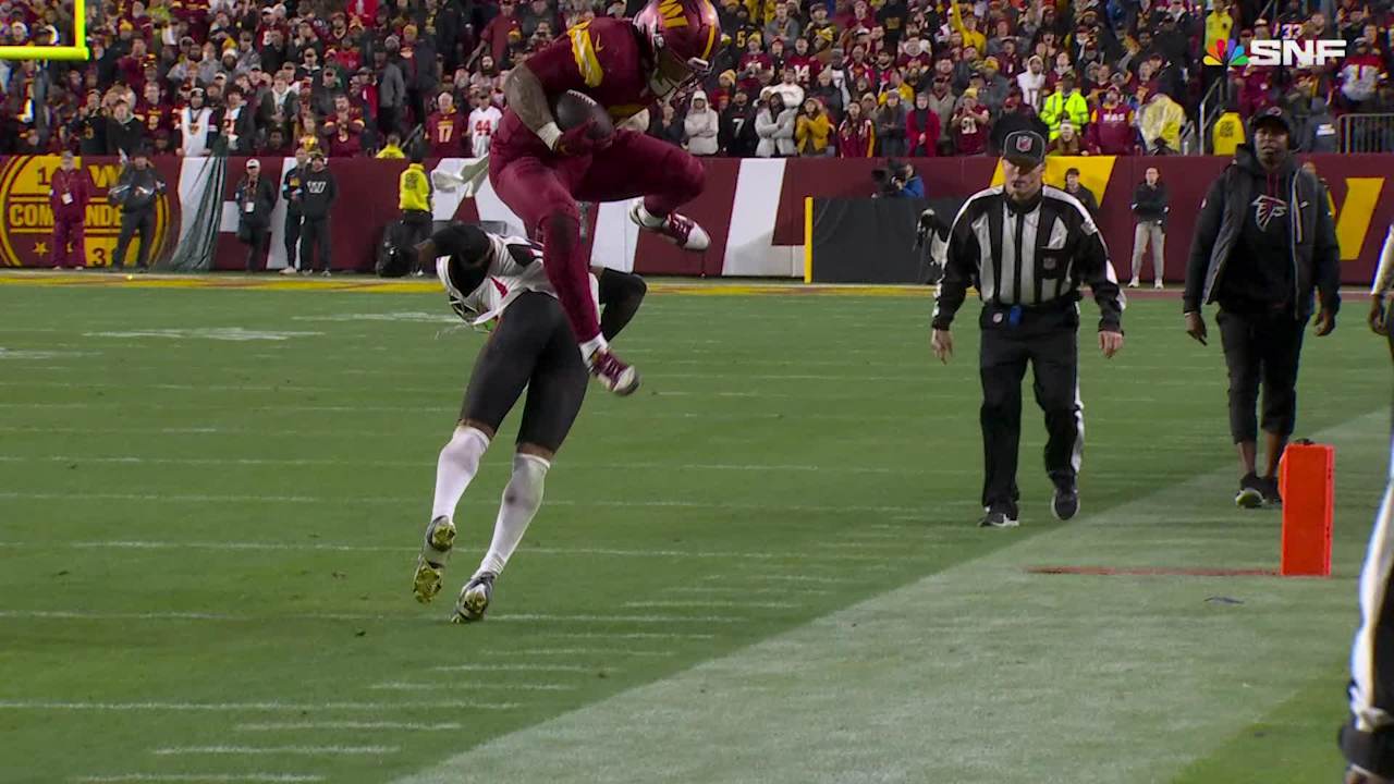 Washington Commanders running back Chris Rodriguez Jr. hits the hurdle ...