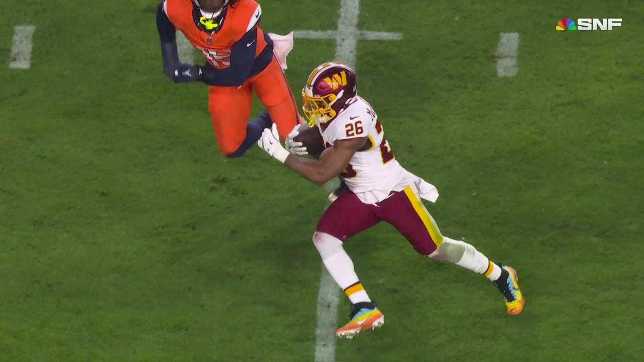 Washington Commanders running back Jeremy McNichols hits a spin move ...