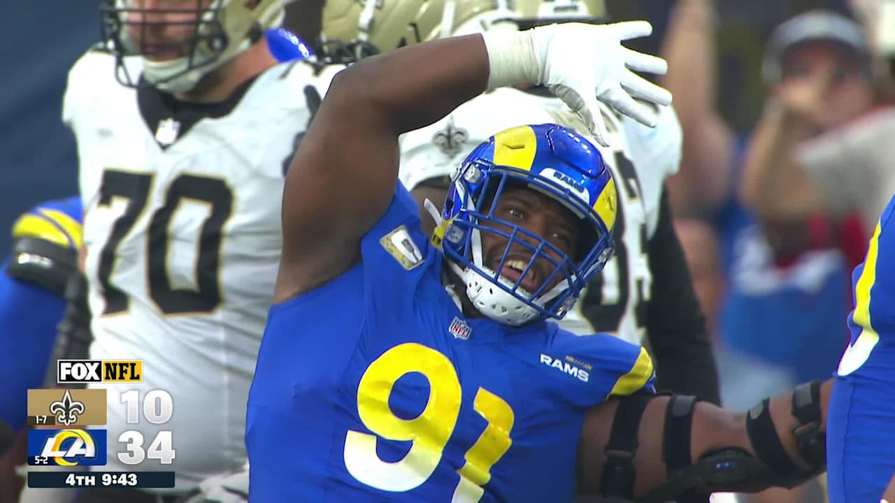 Los Angeles Rams defensive end Kobie Turner hits a Los Angeles Dodgers ...