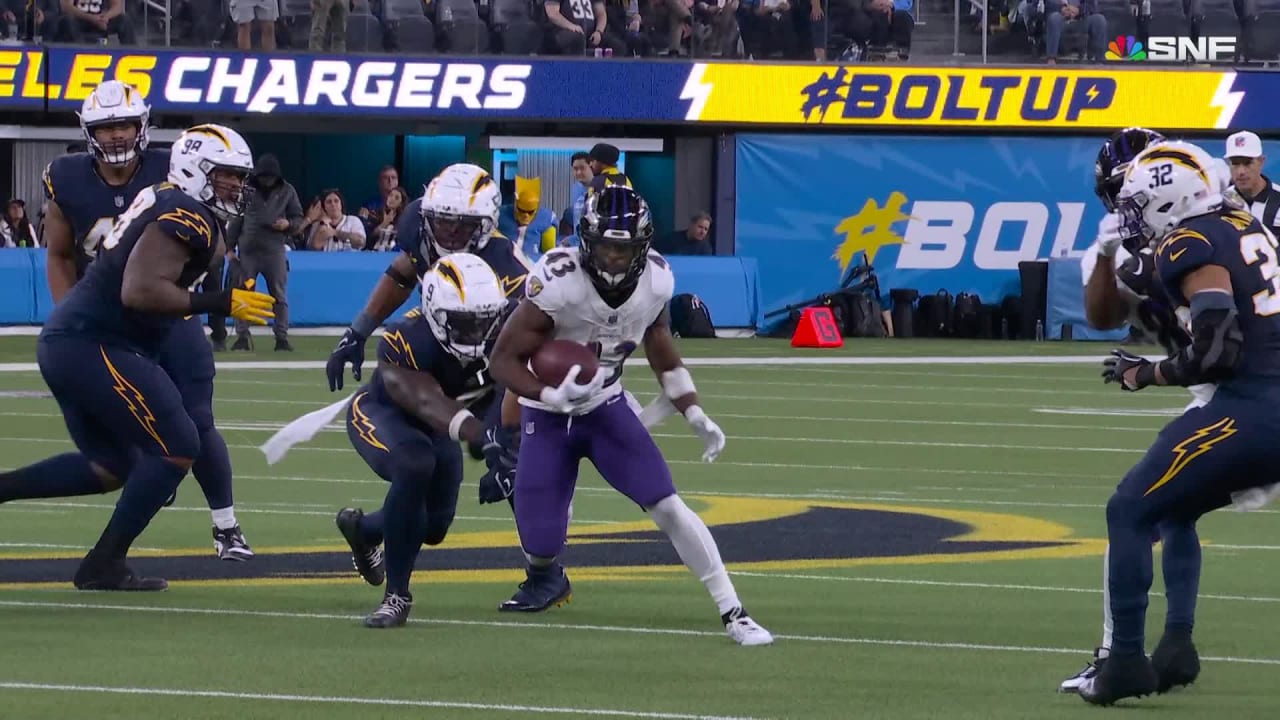 Baltimore Ravens running back Justice Hill breaks through the hole for ...