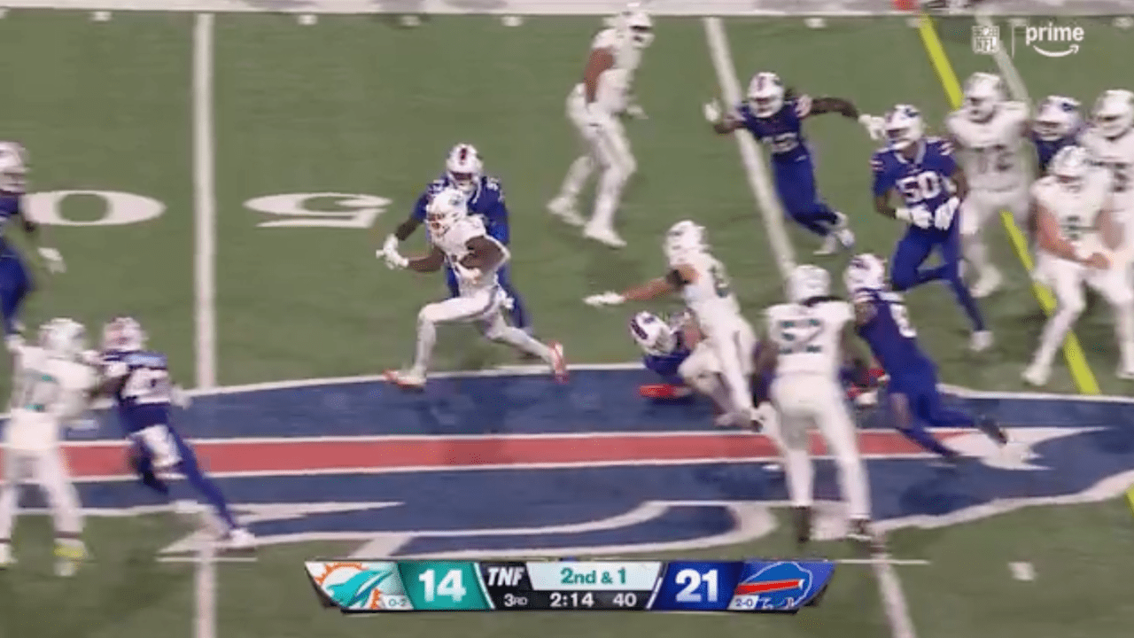 Miami Dolphins running back Ollie Gordon II rumbles up the middle for ...