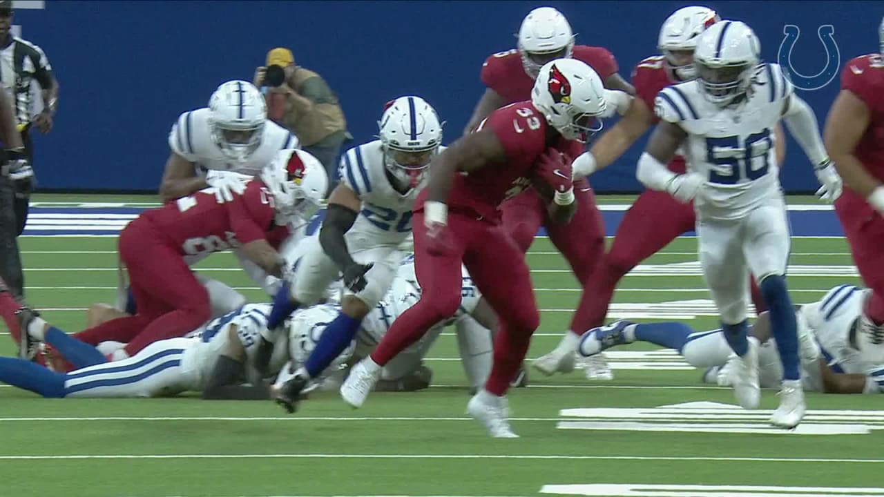 Arizona Cardinals running back Trey Benson bursts through a crease for ...