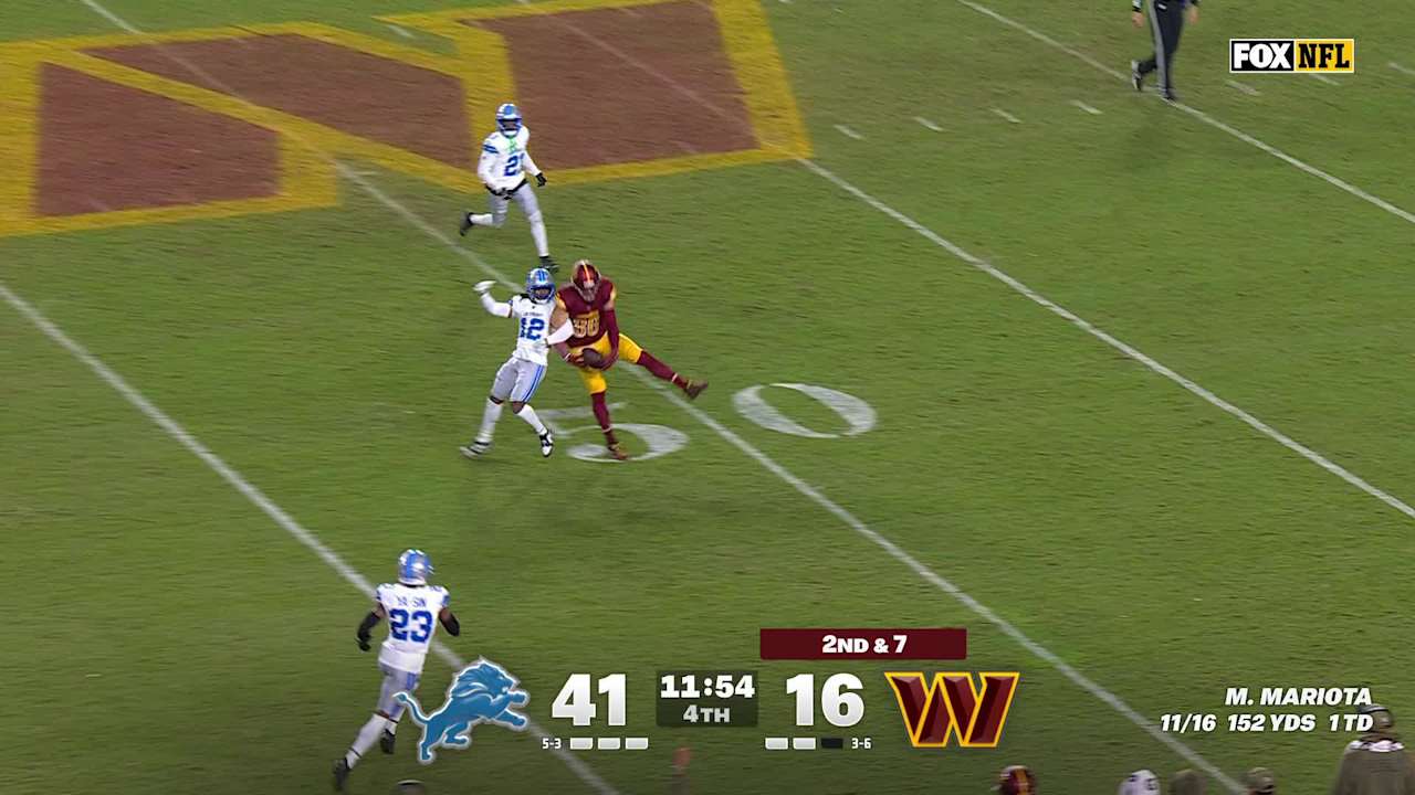 Washington Commanders tight end Zach Ertz Mosses Detroit Lions defender ...